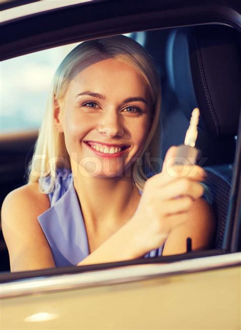 Happy Woman Getting Car Key In Auto Show Or Salon Stock Image Colourbox