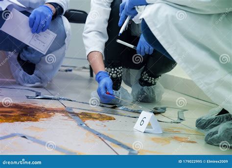 Forensic Technicians Taking Dna Sample From Blood Stain With Cotton
