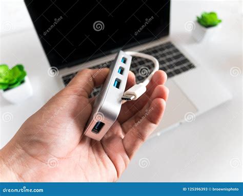 Man Hold A USB To Type C Hub Adapter With Laptop In The Background Stock Image Image Of