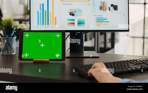 Businesswoman Reviewing Digital Tablet With Greenscreen Template In