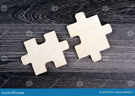 Two Puzzle Pieces In A Row On A Wooden Background Stock Photo Image Of Business Creation