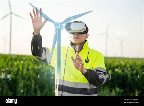 Engineer Examining Augmented Wind Turbine Model Through Virtual Reality Simulator Stock Photo