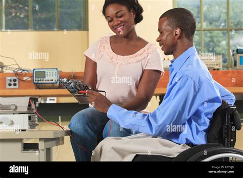 Engineering Students Making Measurement On Microcontroller Board In An