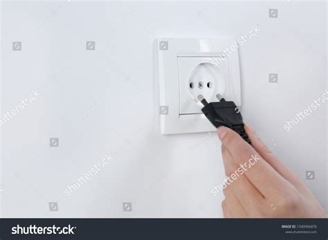 Woman Putting Plug Into Power Socket Stock Photo Shutterstock