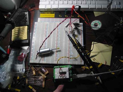 an electronic device is sitting on top of a desk next to a keyboard and