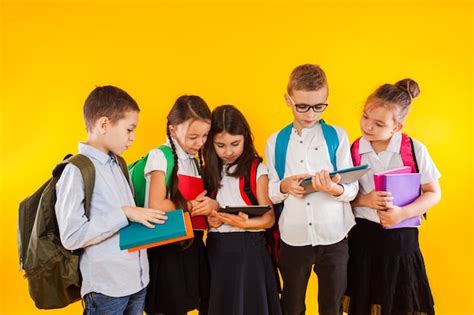 Premium Photo Group Of Classmates Reading Books And Ebooks
