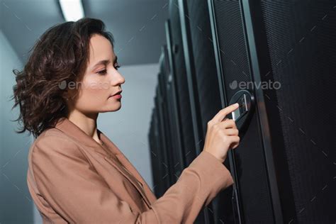 Programmer Touching Control Panel While Making Diagnostics Of Server In