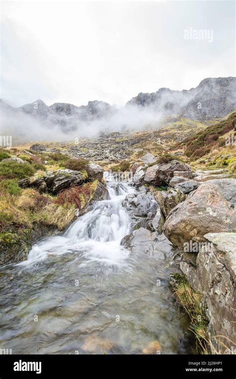 Low Pov Of A Babbling Brook Creating A Small Waterfall As Water Is