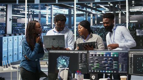 Portrait Of Smiling Data Center Specialists Collaborating In Server