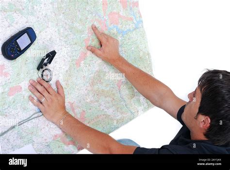 Man Sitting And Looking At Maps In His Hands Stock Photo Alamy