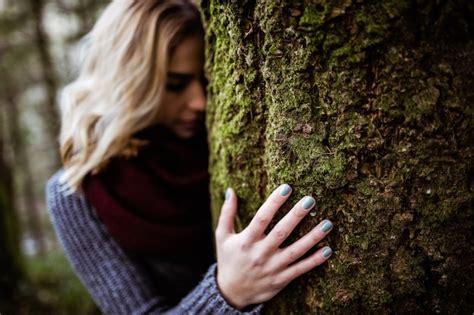 Premium Photo Woman Leaning On Tree Trunk