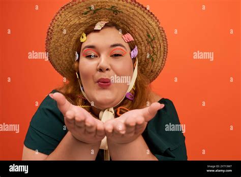 A Cheerful Plus Size Woman Blows Kisses Flaunting Her Colorful