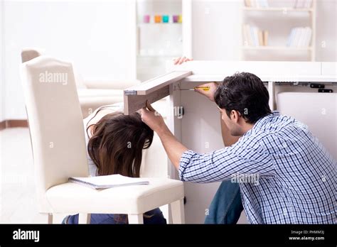 Husband Repairing Broken Table At Home Stock Photo Alamy