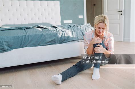 Woman Hugging Her Leg Crossed At Knee Sit Near Bed High-Res Stock Photo ...