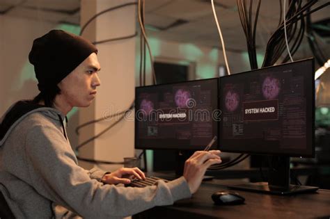 asian hacker looking at firewall encryption to hack server stock image
