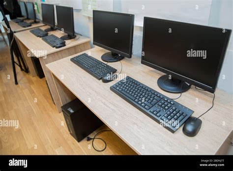 Two Computers And A Desk Keyboard And Mouse Two Computer Monitors With A Black Screen On A