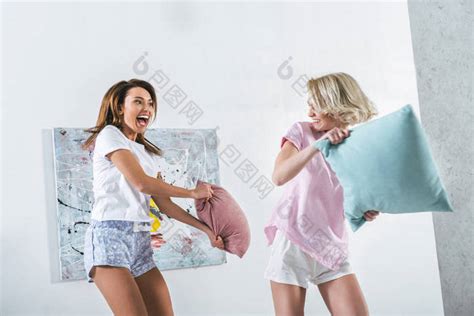 兴奋的女孩在床上枕头打架早上图片 包图网企业站