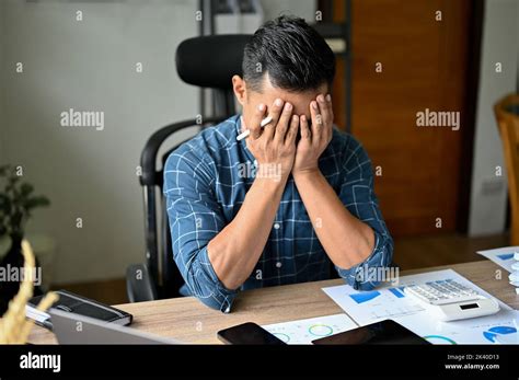 stressed asian businessman or male business startup entrepreneur