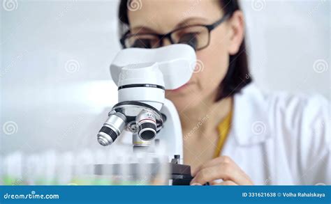 Woman Scientist Using Microscope In Laboratory Microbiology Science