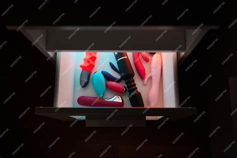 Premium Photo Different Sex Toys In Open Chest Of Drawers