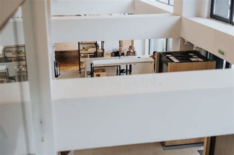 Cross Generational Business Team Discussing Project Solutions In Modern Office Successful