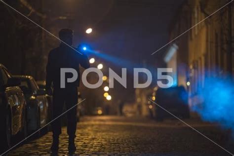 The Man With A Flashlight Stand On The Road Evening Night Time Stock