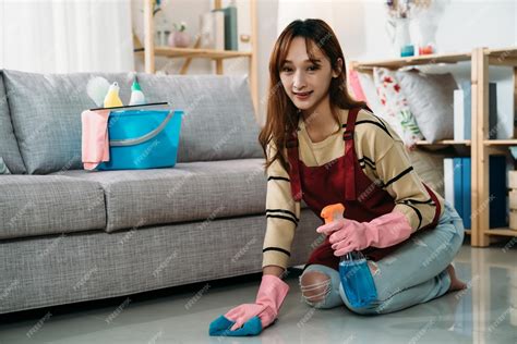 Premium Photo Attractive Female Housekeeper Sitting On Her Knee Is