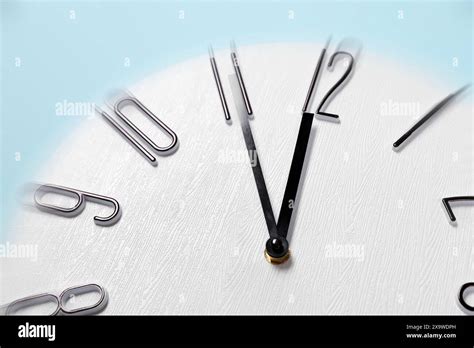 Closeup View Of Clock On Light Blue Background Motion Blur Effect Time Concept Stock Photo Alamy