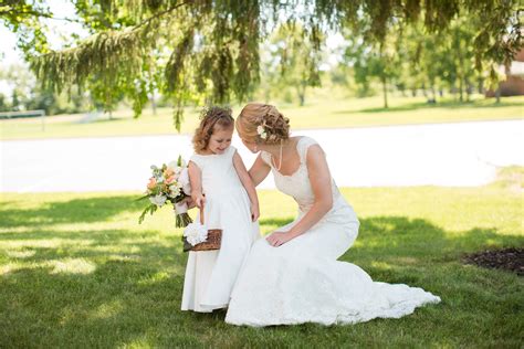 Bride Kneeling With Flower Girl