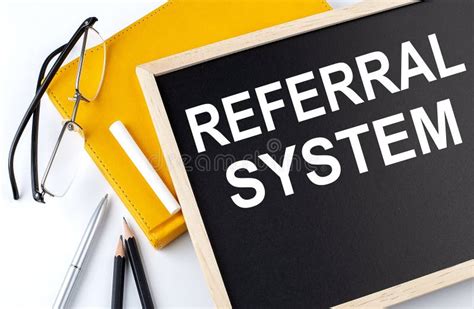 Referral System Text On The Blackboard With Notepad Pen Pencil Stock
