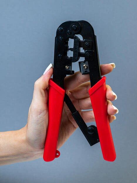 Premium Photo Hands Holding Crimp Tool For Crimping Of The Round