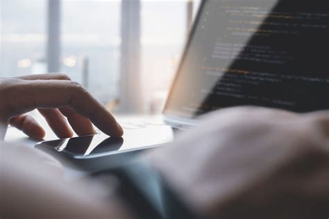 premium photo computer programmer mobile app developer using mobile phone and coding