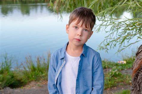 Premium Photo Portrait Of A Cute Boy On The Background Of The Lake In