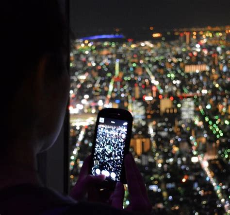 Premium Photo Man Photographing Illuminated Cityscape At Night