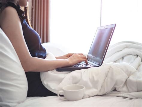 Premium Photo Midsection Of Woman Using Mobile Phone On Bed