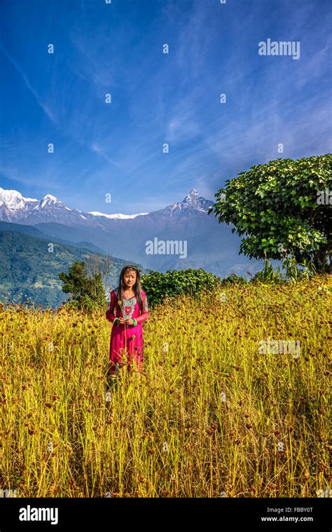 Young Girl Plays On A Field In The Himalayas Mountains Near Pokhara