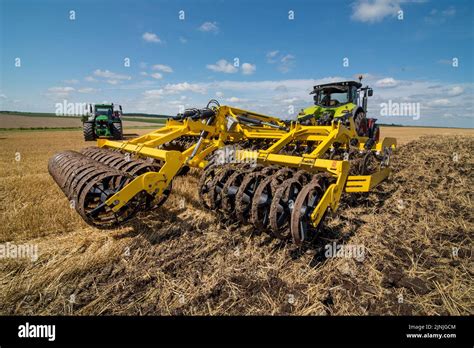 Multi Disc Cultivator Tillage System In Operation With Tractor Stock