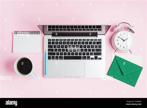 Open Laptop Pencil Alarm Clock Spiral Notepad Envelope Pink Background