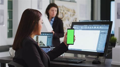 Engineer Showing Phone With Greenscreen Template On Display Working At A Architectural Agency
