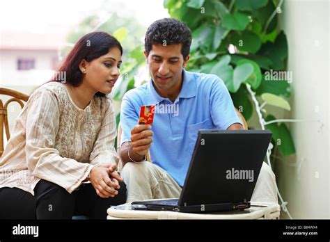 A Couple Using Laptop Stock Photo Alamy