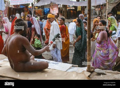 Naga Naked Sadhu From The Juna Akhara Looking Out To Passing Pilgrims From His Ashram