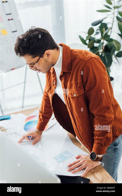 Selective Focus Of Ux Developer Looking At Wireframe Sketches Of Ux