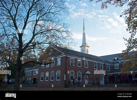 White Spire Of Church Protruding Into Partially Clouded Blue Sky In