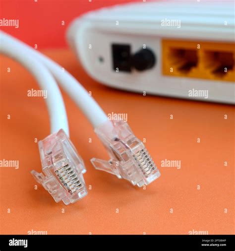Internet Router And Internet Cable Plugs Lie On A Bright Orange Background Items Required For