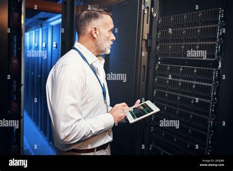 It Support Are The Unsung Heroes A Mature Man Using A Digital Tablet While Working In A Server
