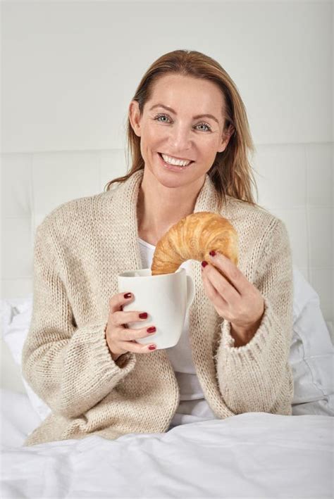 Portrait Of A Beautiful Woman Smiling While Having Breakfast Stock
