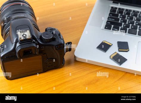 Digital Camera Laptop And Memory Card On Wood Table With Copy Space For Text Or Design Stock