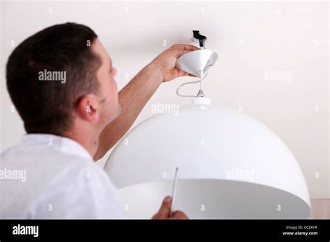 Man Fixing Ceiling Light Stock Photo Alamy