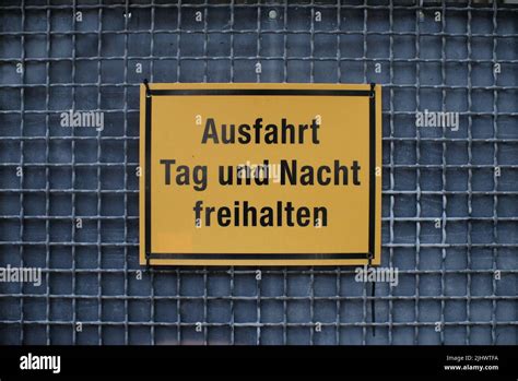A Yellow Sign On An Entrance Gate Keep Exit Day And Night Clear Stock Photo Alamy