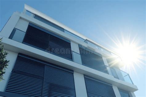 The Array Of Solar Panels On Top Of A Building Exemplifies The